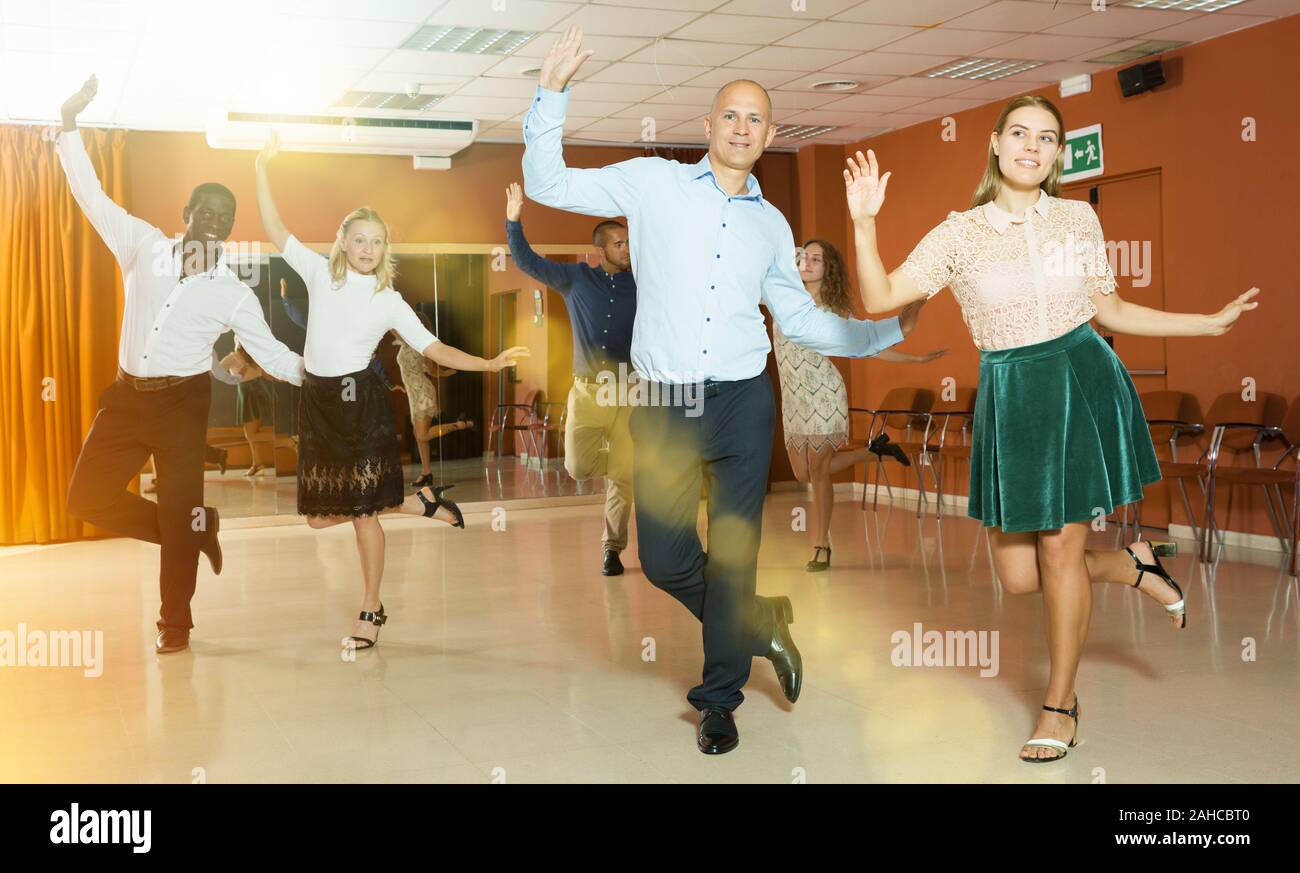 Adult dancing couples enjoying rhythmic tap dance in dance studio Stock ...