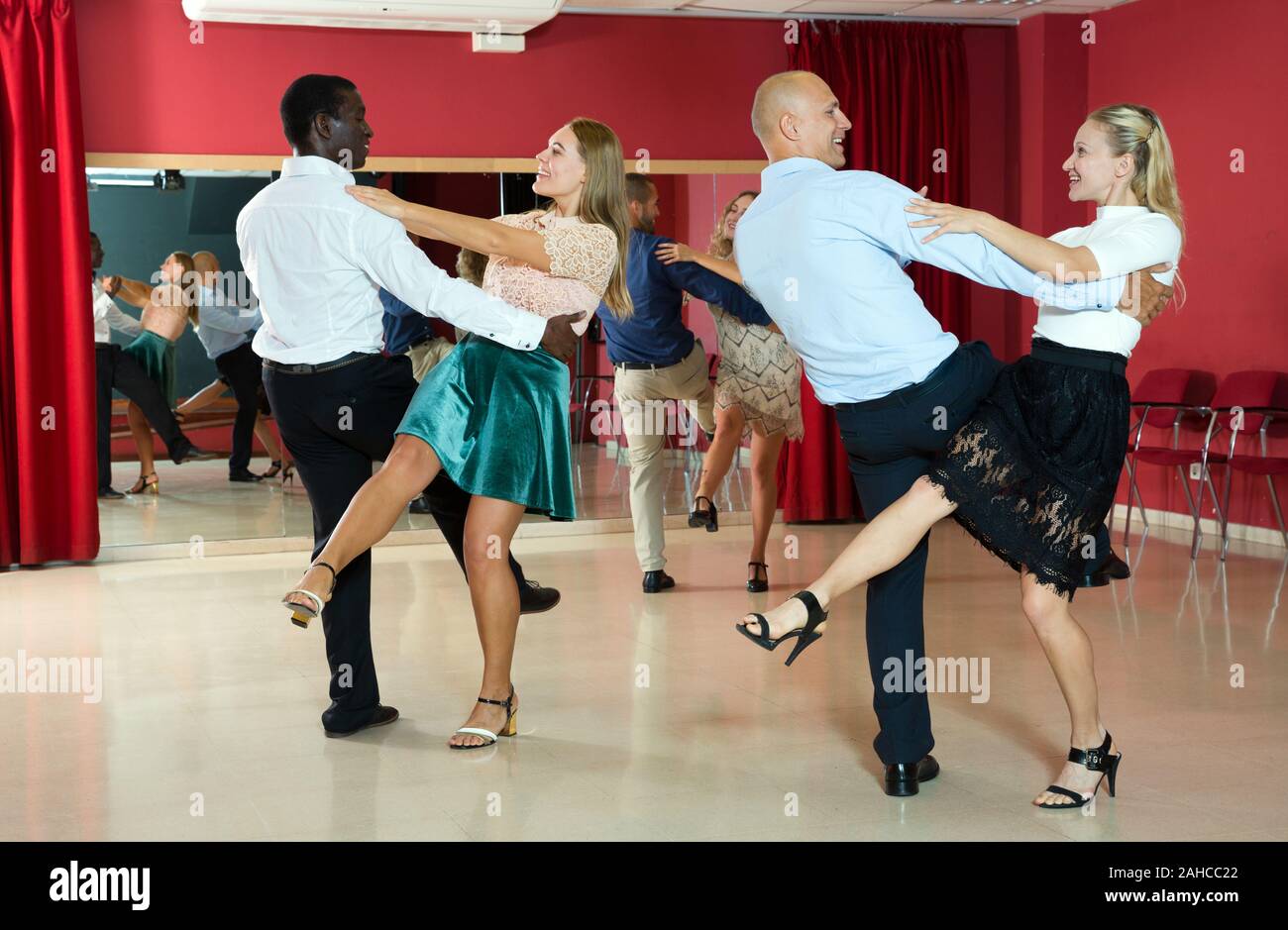 Young positive people dancing rock-and-roll in pairs Stock Photo - Alamy