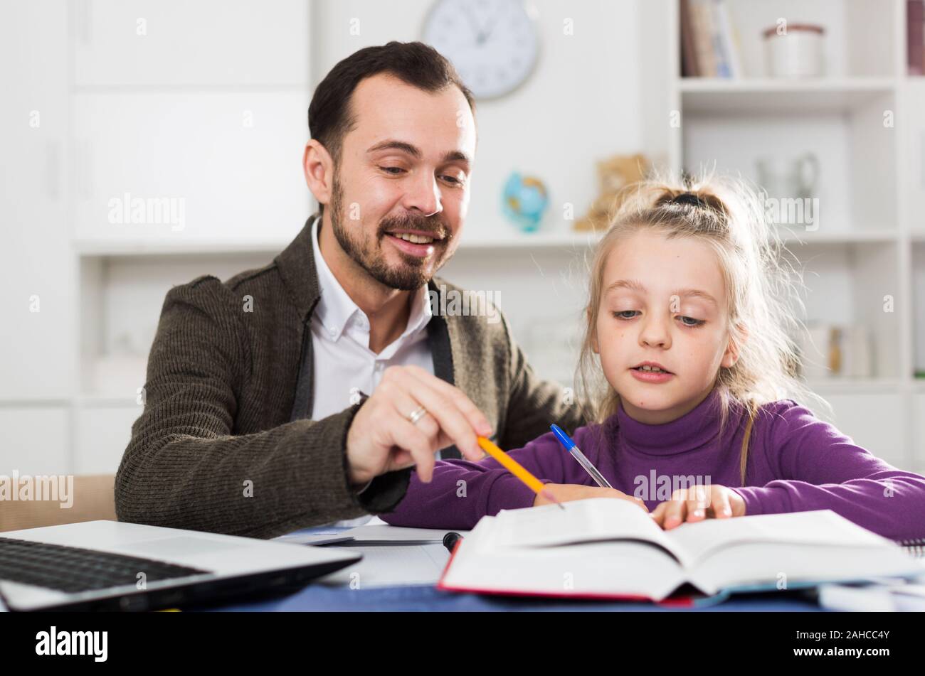 Father helping his child to do homework at home Stock Photo - Alamy