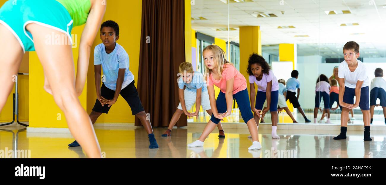 smiling sportive children dancing synchronous group choreography with ...