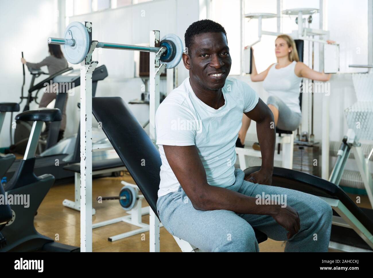 Group of people exercising with weight and on simulators in gym Stock ...