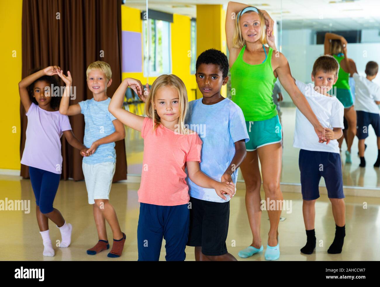 Positive little boys and girls dancing pair dance in the ballet studio ...