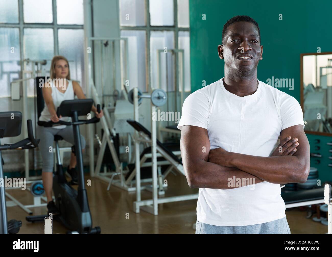 Portrait of adult african man in sportswear welcoming to sport club ...
