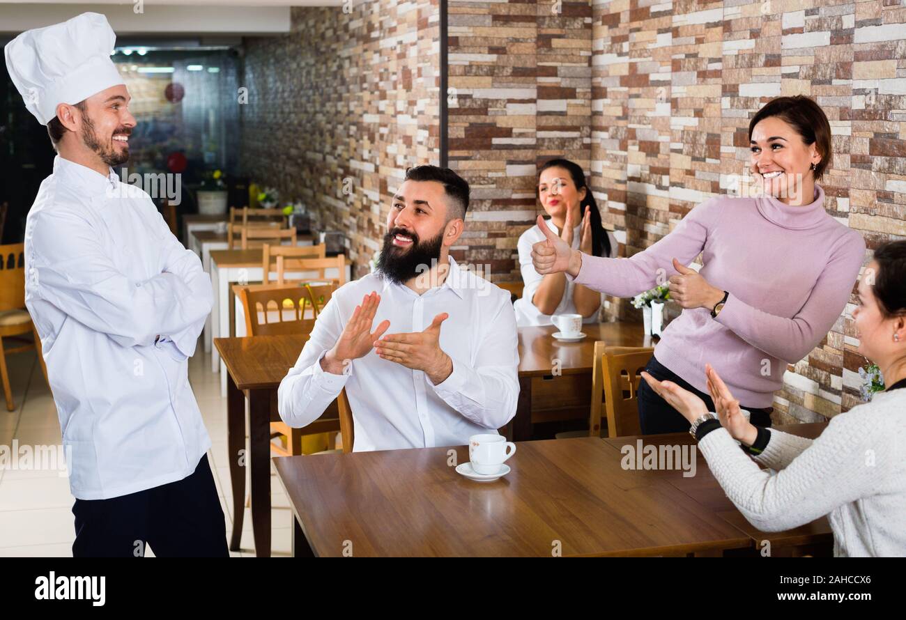 Happy positive chef listens to praise of the food Stock Photo - Alamy