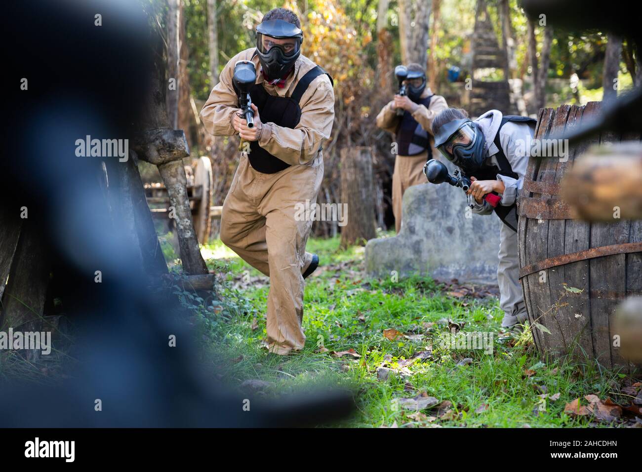 Teams of friends facing on battlefield in outdoor paintball arena Stock ...