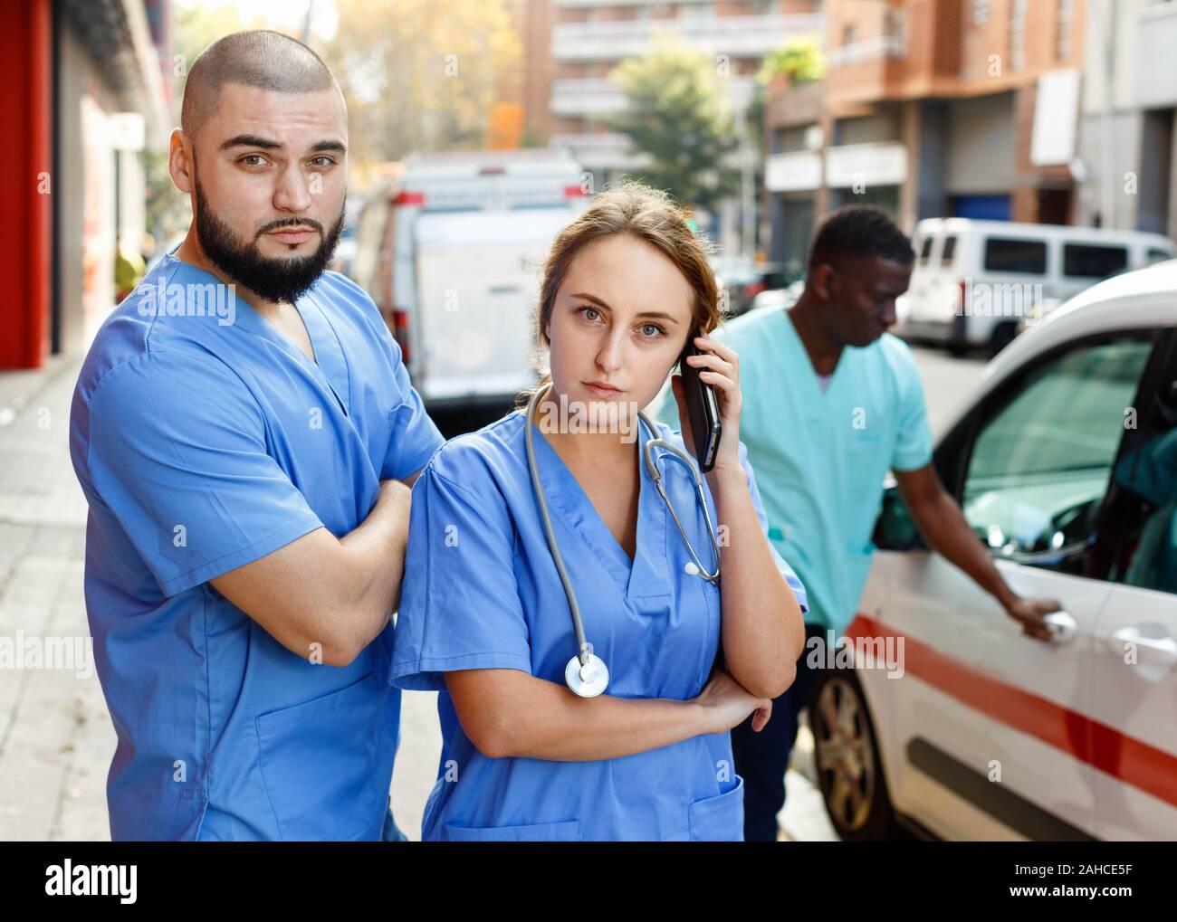 Positive friendly efficient paramedics with first aid kit going to call ...