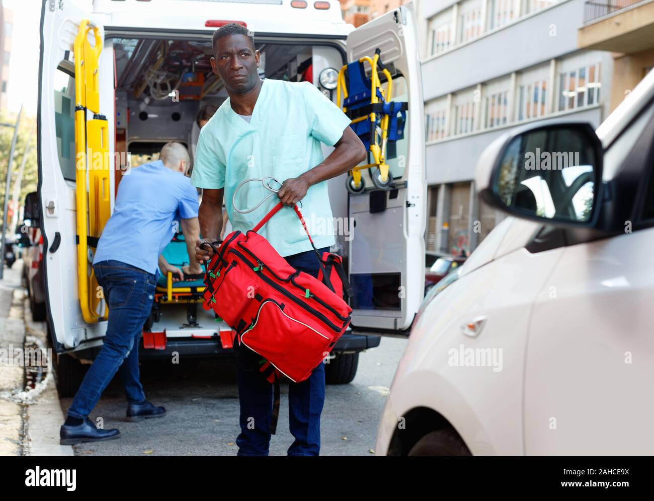 Three positive glad pleasant friendly ambulance doctors posing in ...