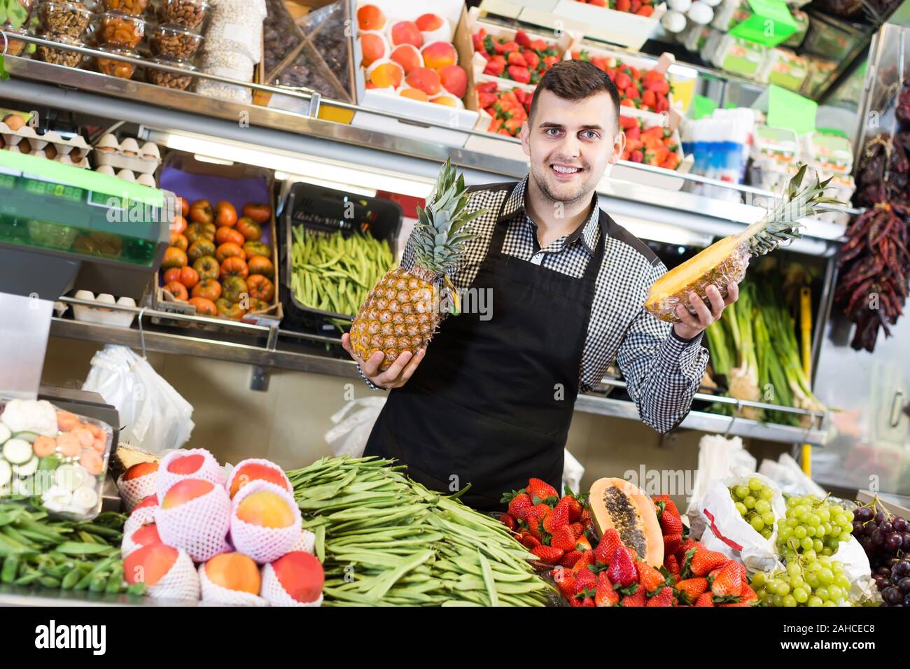 happy european male shopping assistant demonstrating assortment of ...