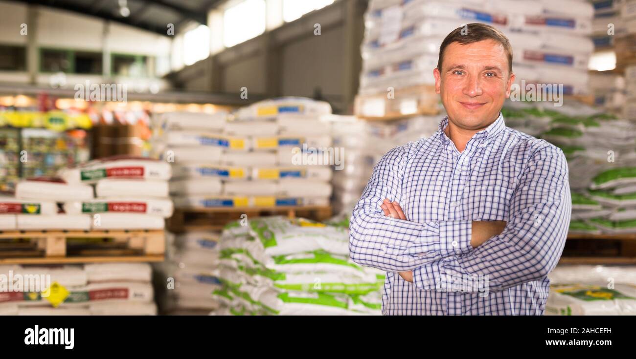 Portrait of male who is standing in hardware store Stock Photo - Alamy