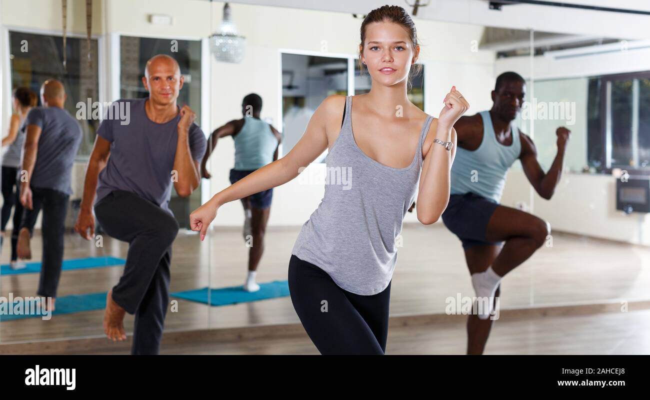 happy dancing people practicing vigorous swing in dance studio Stock ...