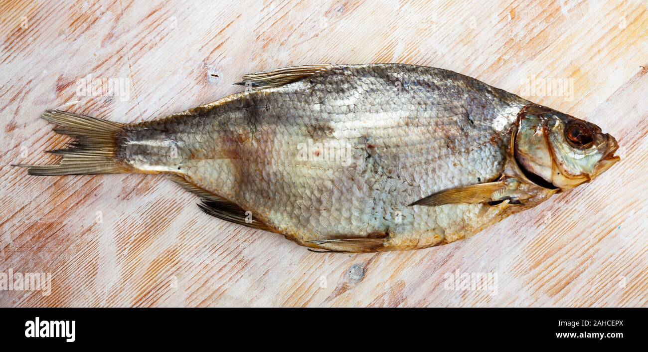 Whole dried salted bream fish on wooden background. Beer snack Stock ...