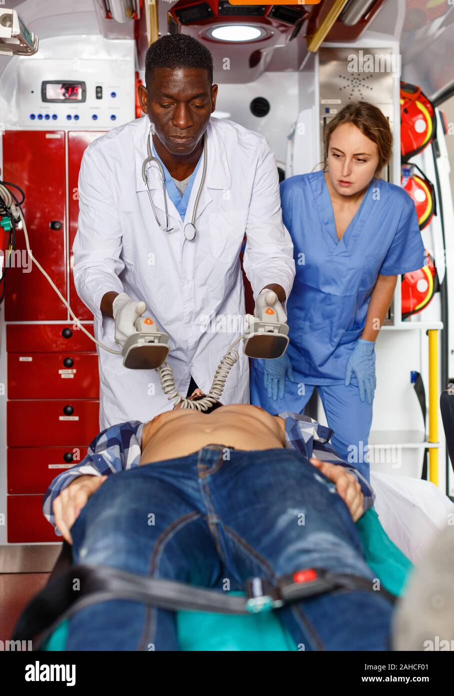Diligent efficient emergency doctor resuscitating male patient with ...