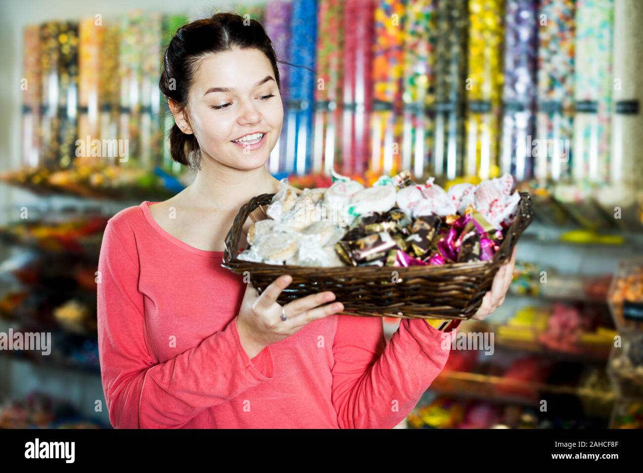 Glad girl in the shop window with lots of sweets Stock Photo - Alamy