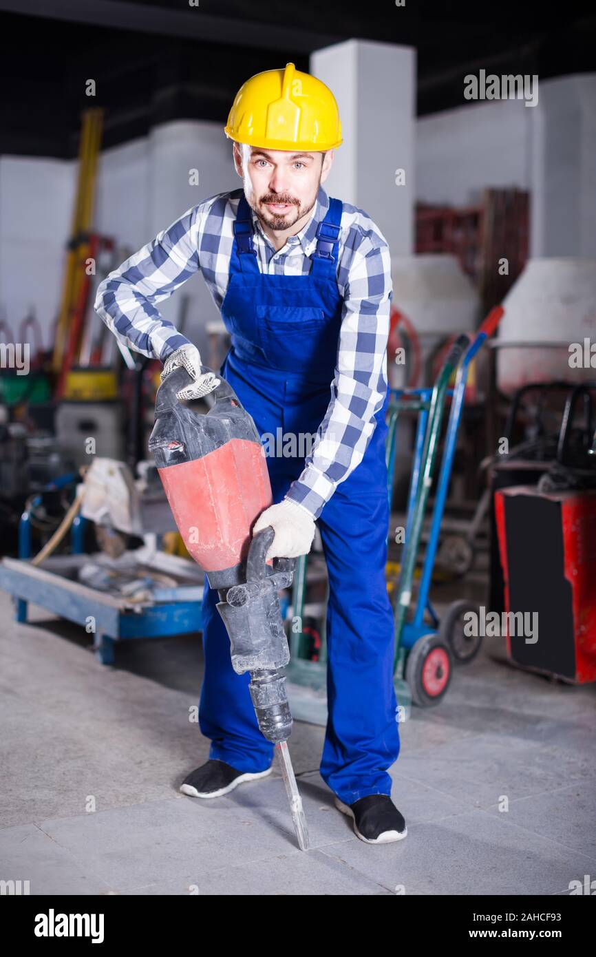 positive american working man practicing his skills with pneumatic ...