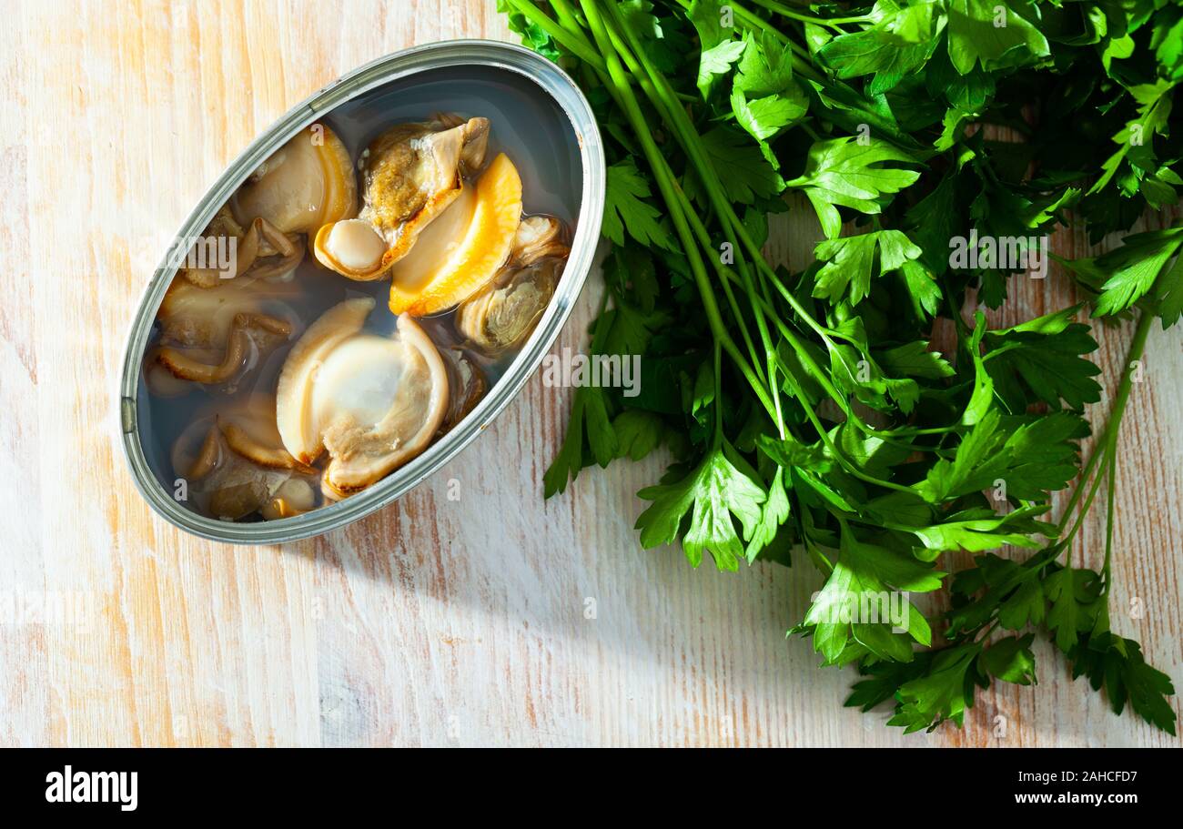 Opened tin can of shellfish fillet in oil Stock Photo - Alamy