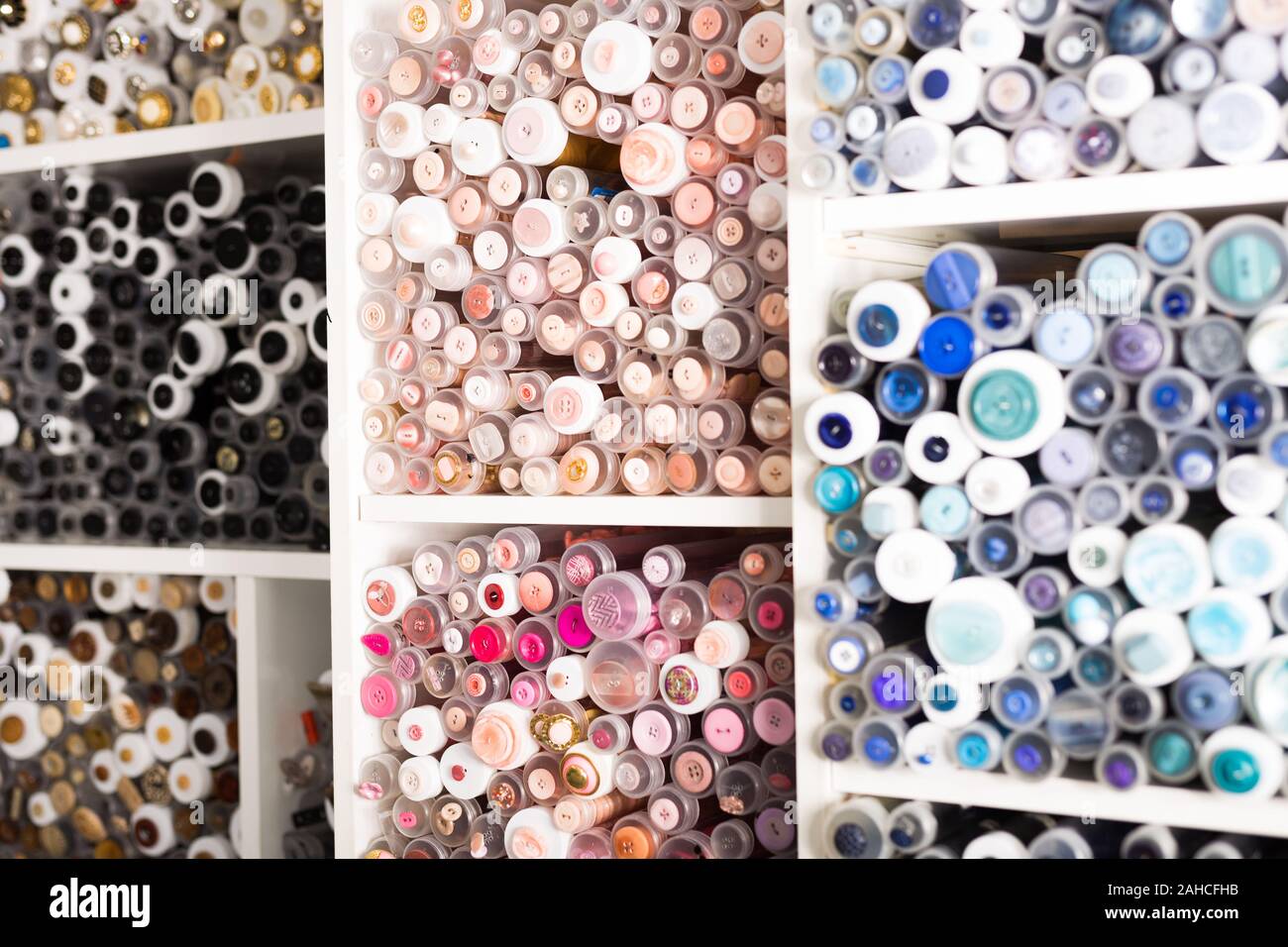 Large assortment of colored buttons of various design in tubes on ...