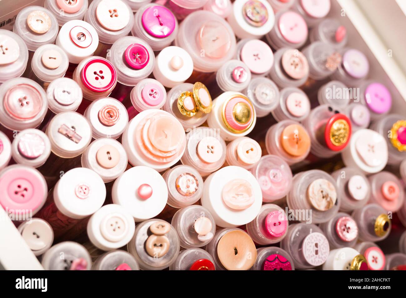 Large assortment of colored buttons of various design in tubes on ...
