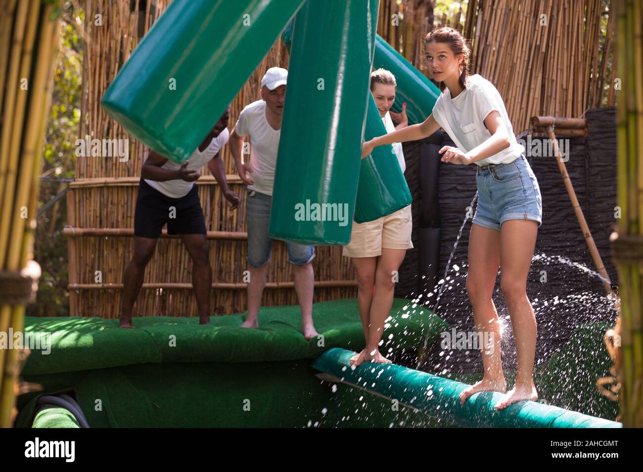 Obstacle course over the water - fun adventure in an amusement park ...