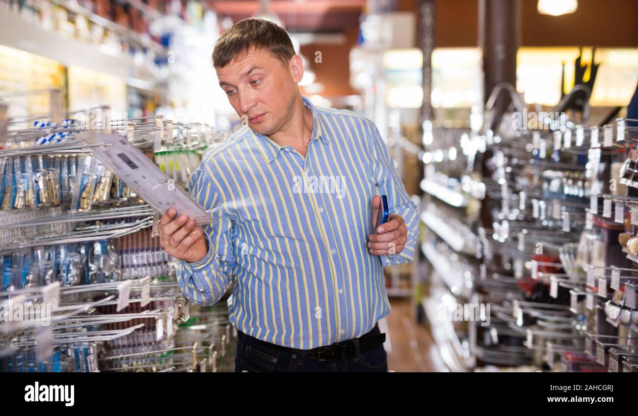 Portrait of customer with a mobile phone at hardware store Stock Photo ...