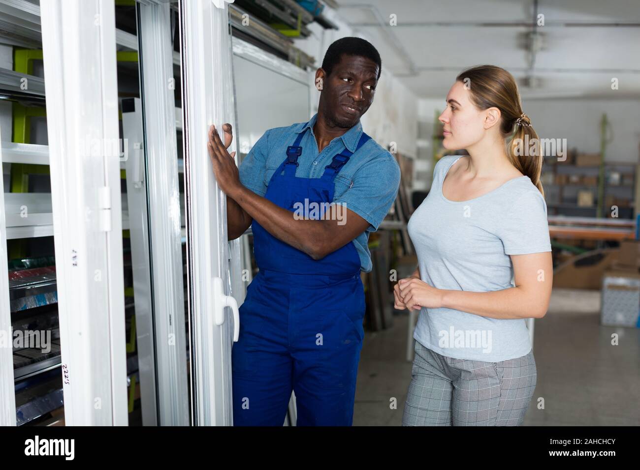 Male master is talking with female client about modern windows in the ...