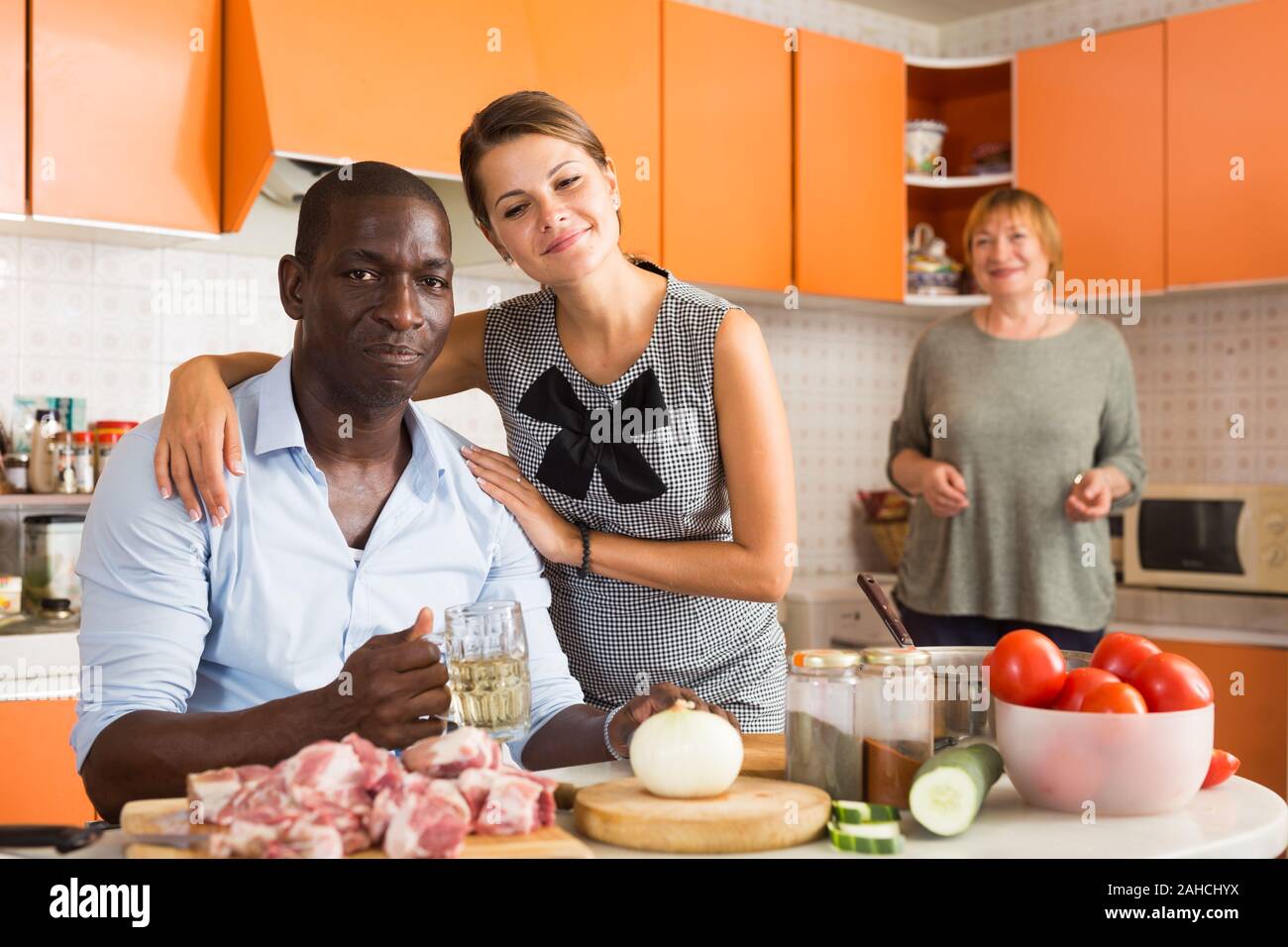 Positive members of big family making dinner together in kitchen Stock ...