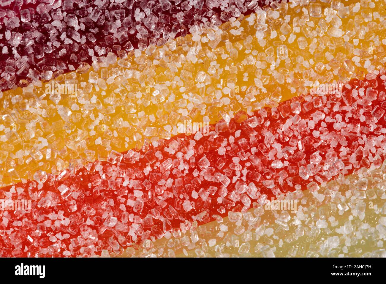 A close up abstract macro photo of a sugar coated multi coloured jelly ...