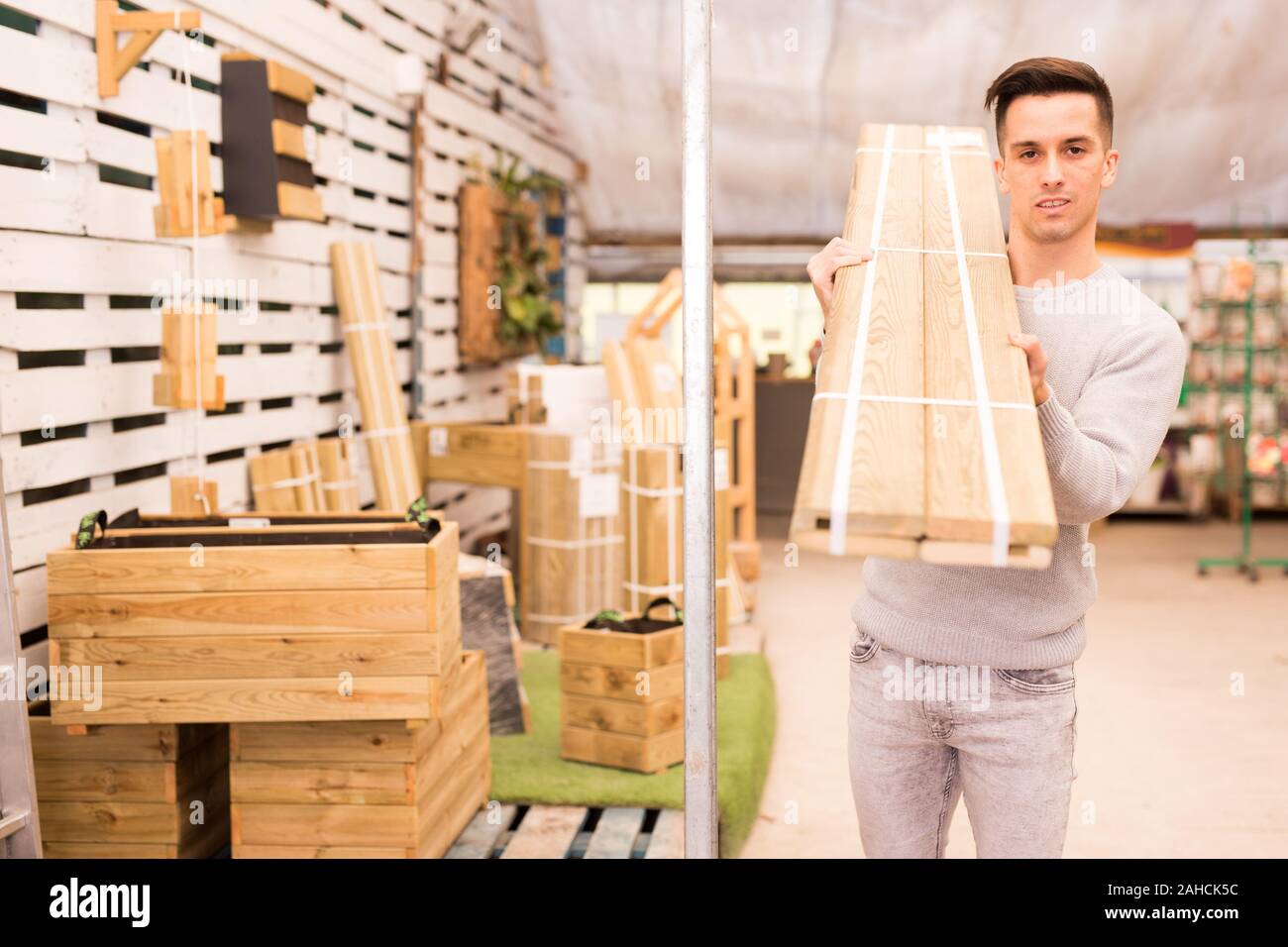 Male customer selecting construction materials in hardware store Stock ...