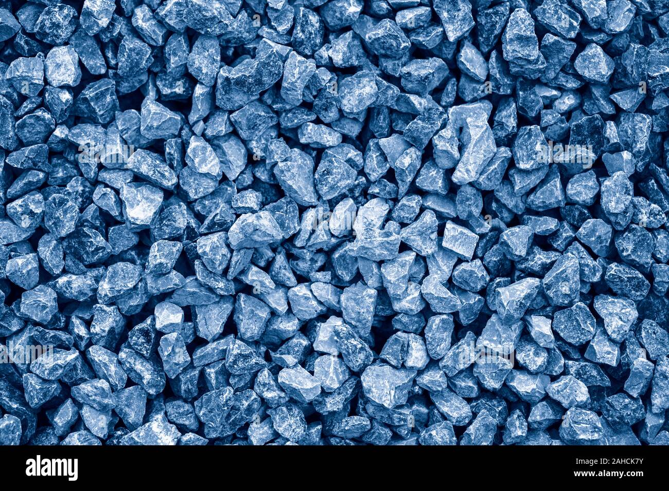 Closeup of small little broken crushed stones rocks lying on ground ...