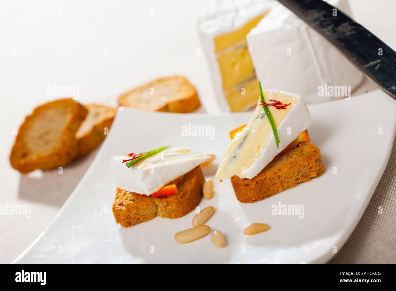 Delicious canapes on toasted bread with soft blue cheese and orange ...