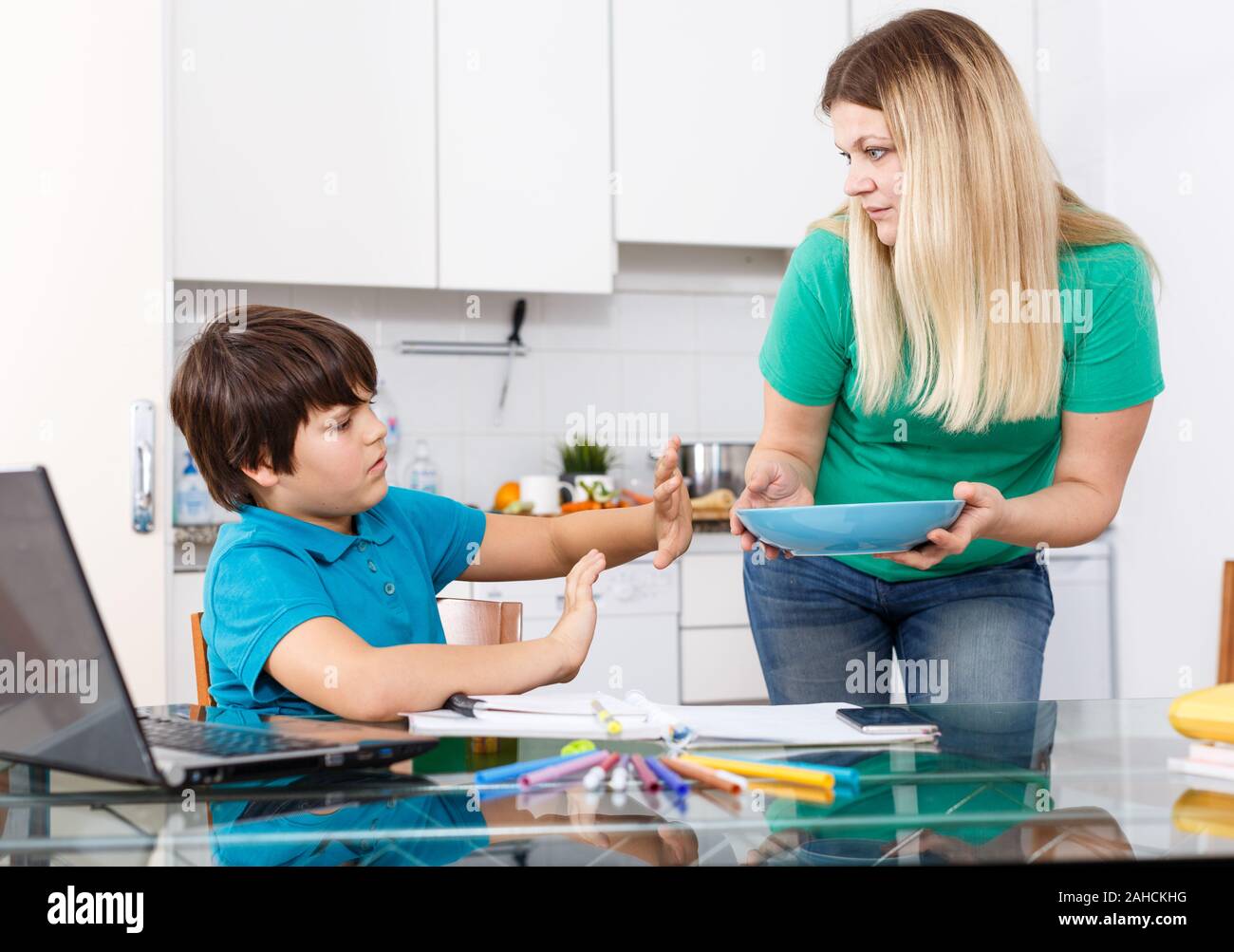 Portrait of displeased boy refusing to eat in kitchen interior Stock ...