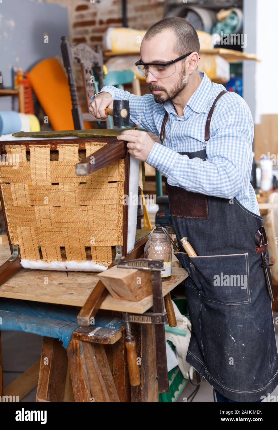 Furniture restorer renovation antique chair in his woodwork studio ...