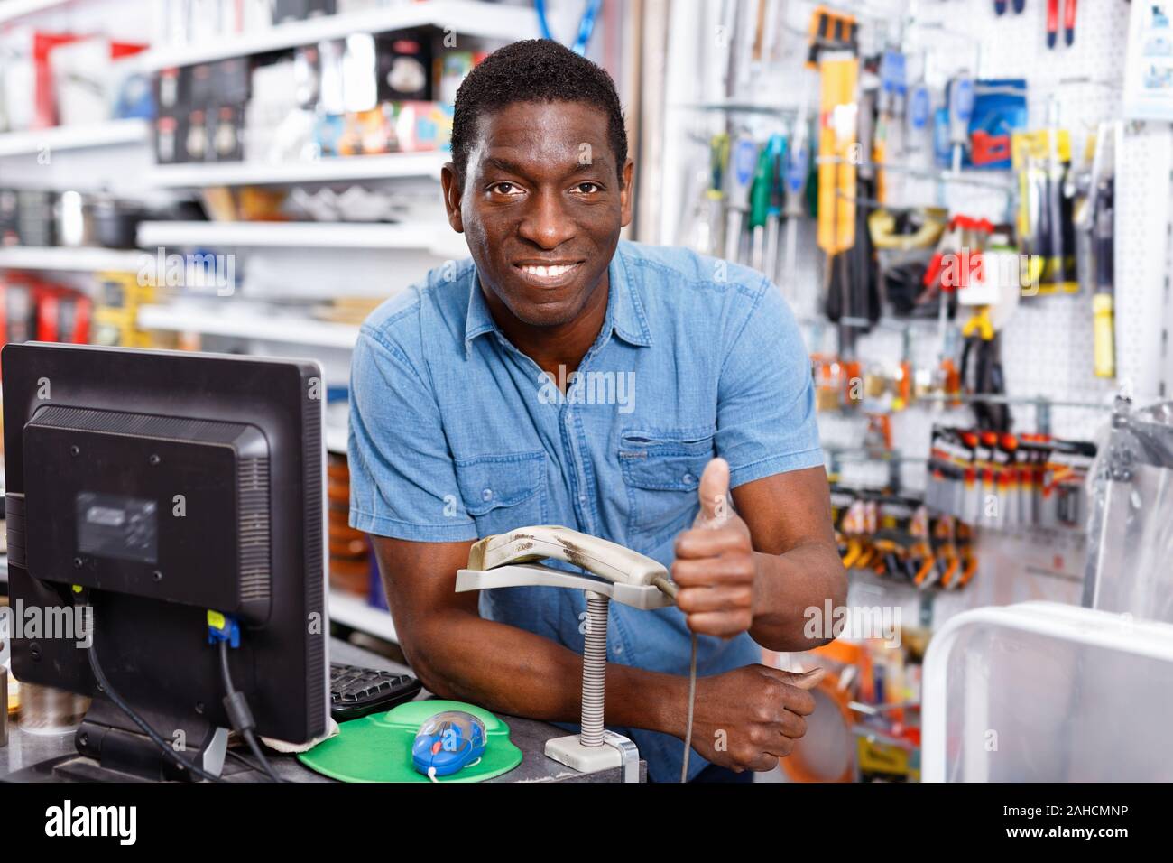 Portrait of pleasant smiling happy successful owner of household goods ...