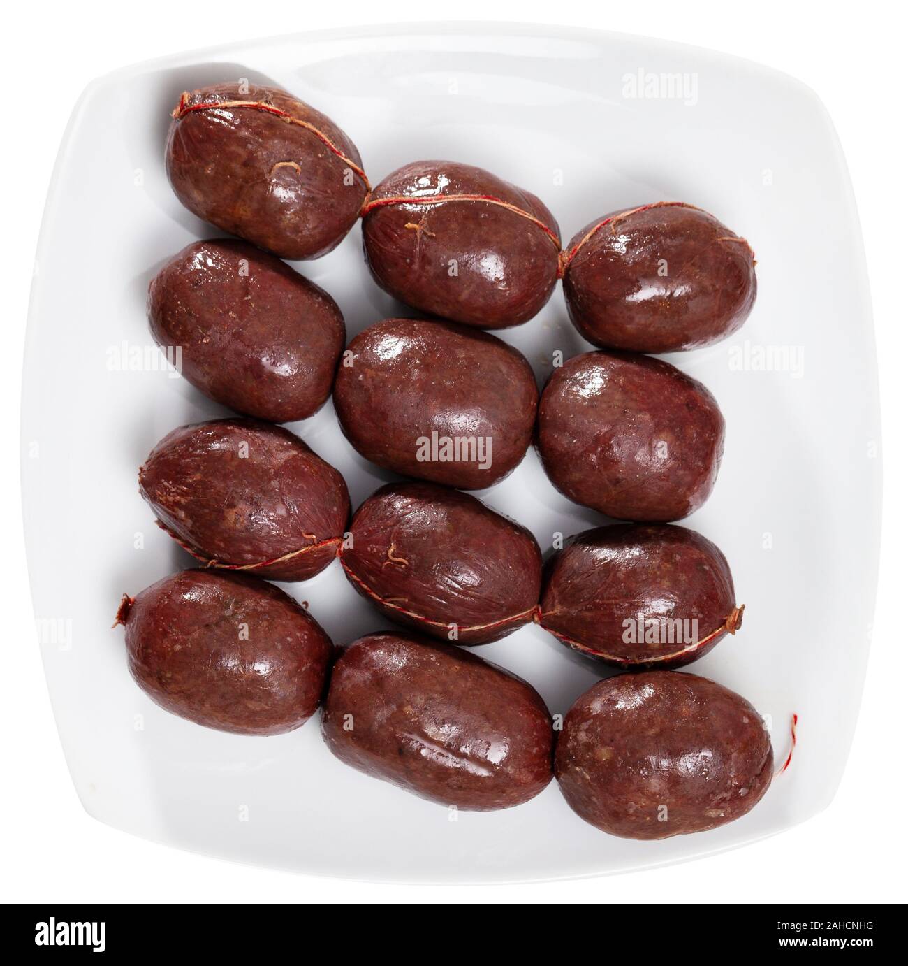 Spanish-style raw morcilla (blood sausage with rice) on white plate ...
