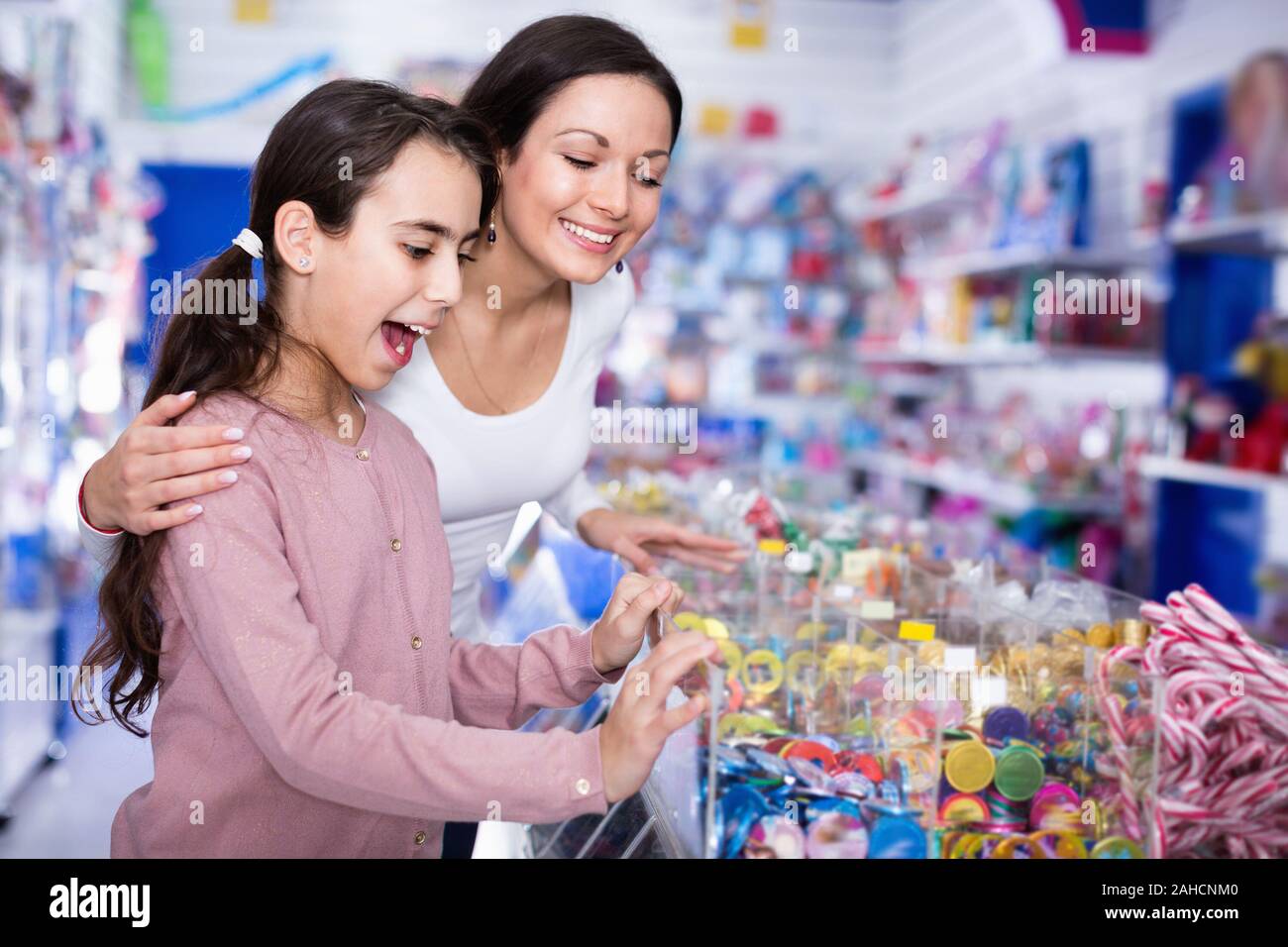 Happy cheerful positive smiling woman with emotional daughter choosing ...
