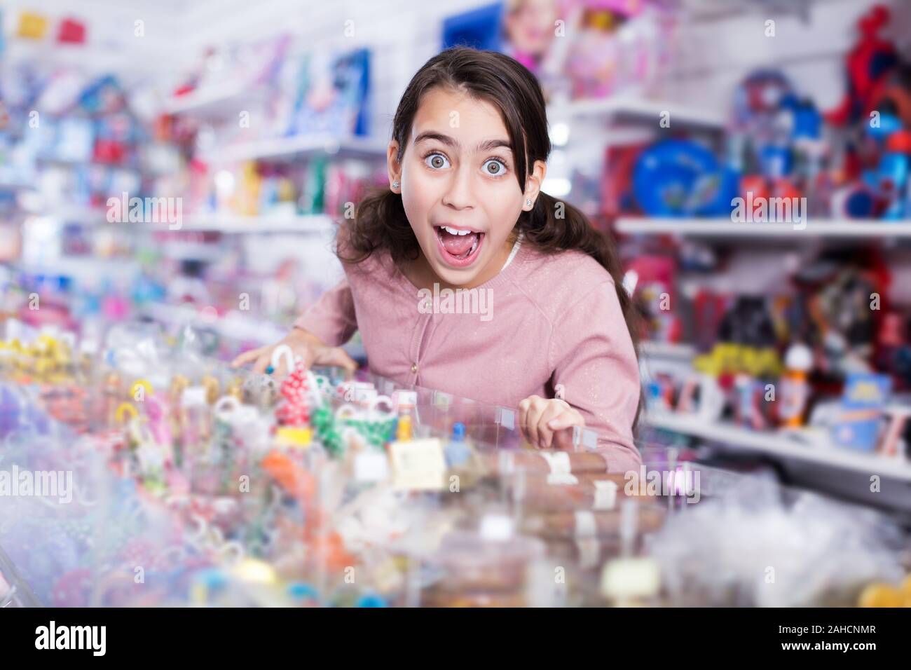 Smiling girl with open mouth buying sweet candies in store Stock Photo ...