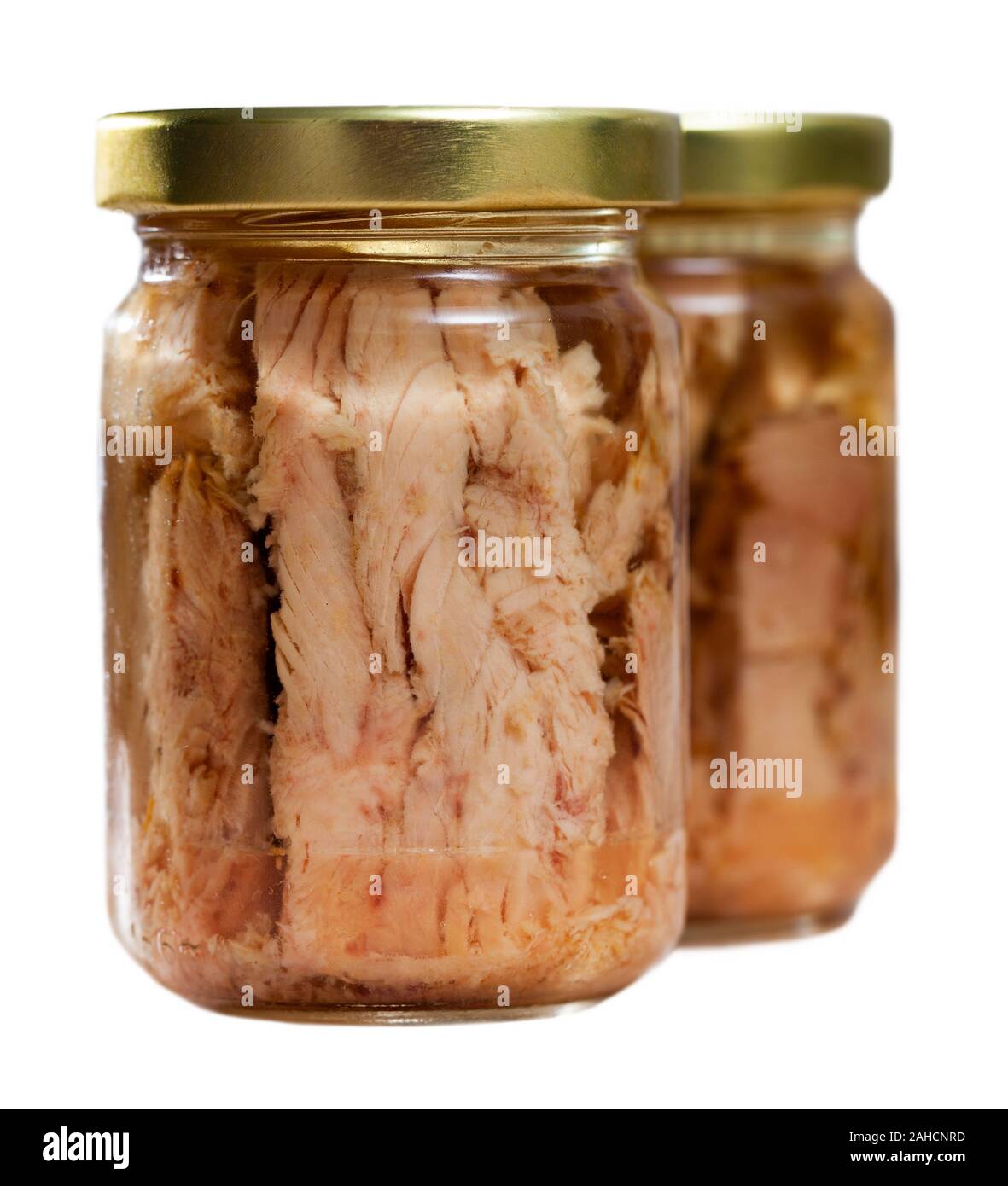 Preserved bonito tuna fish fillets in glass jar. Isolated over white ...