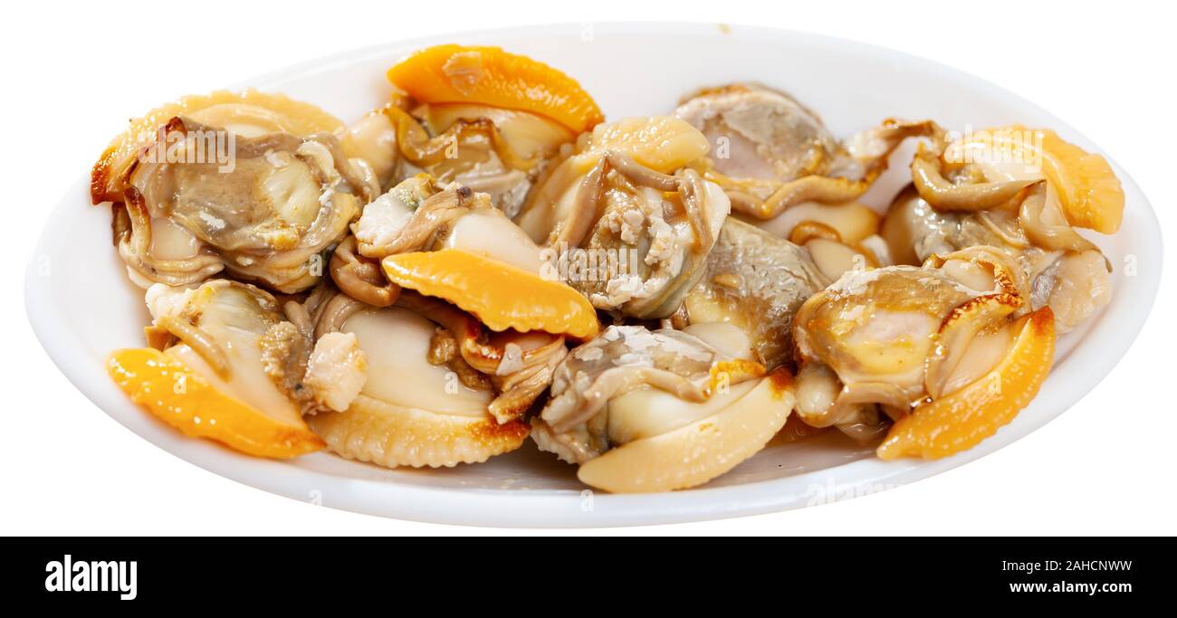 Seafood appetizer. Canned natural shellfish served on white plate ...