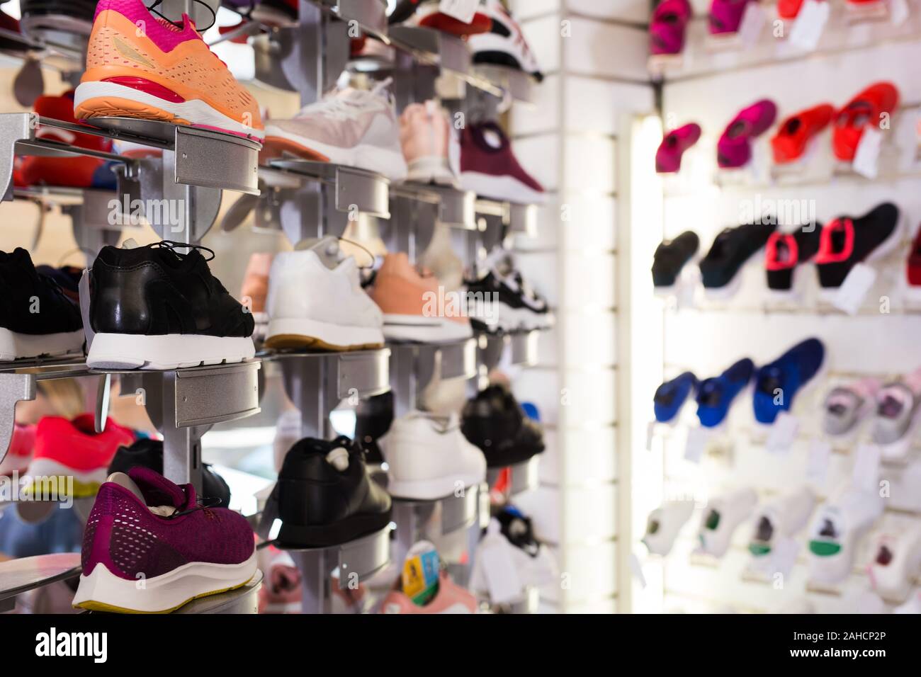 Collection of sneakers on shelves in sports goods store Stock Photo - Alamy