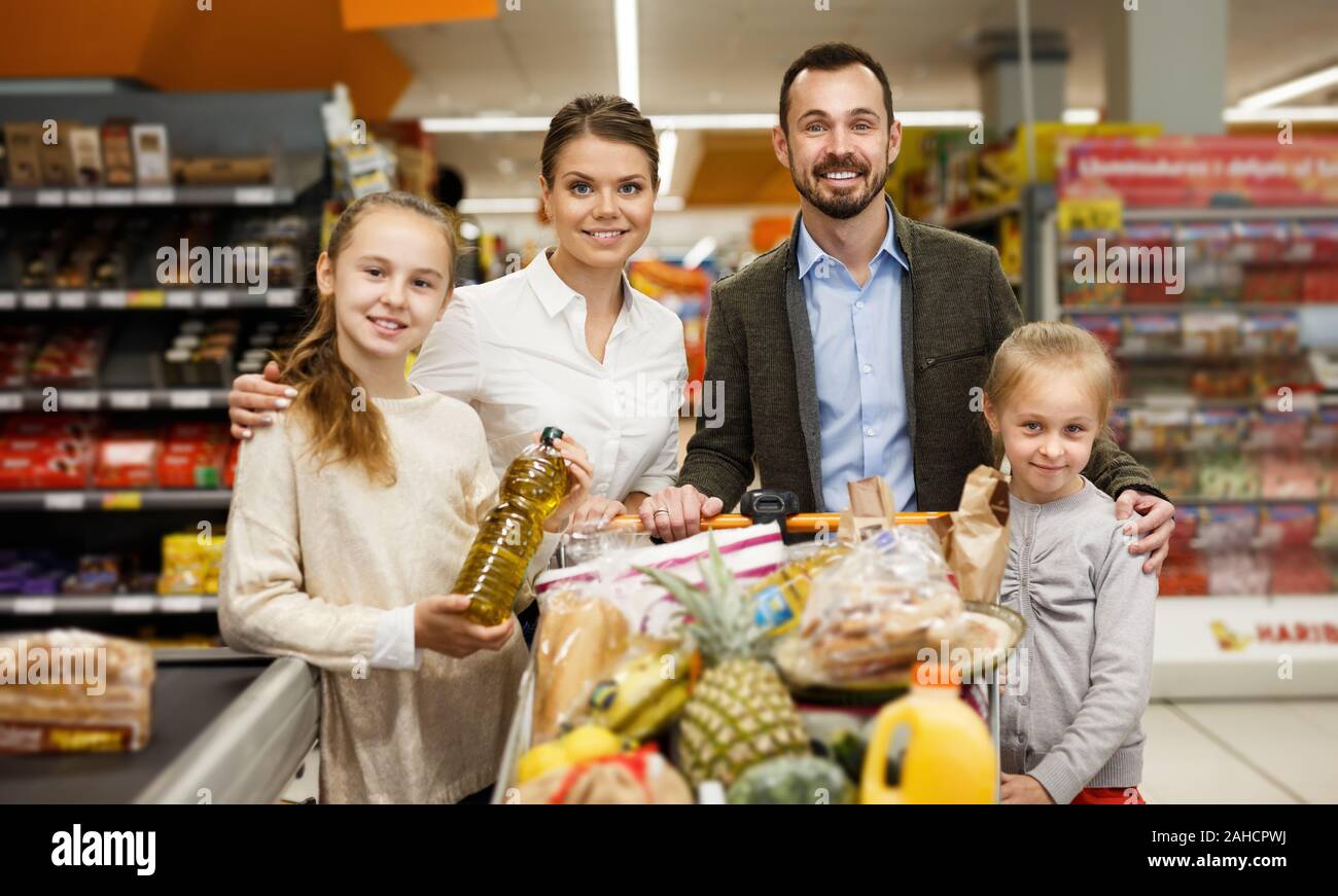 Portrait of happy family children who are standing together in the shop ...