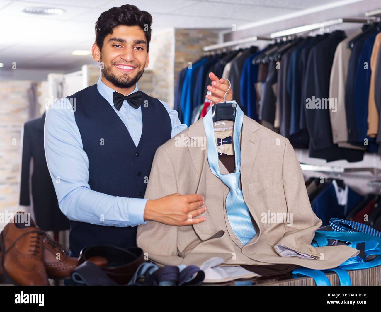 Male client demonstrating his choice of suit in apparel store Stock ...