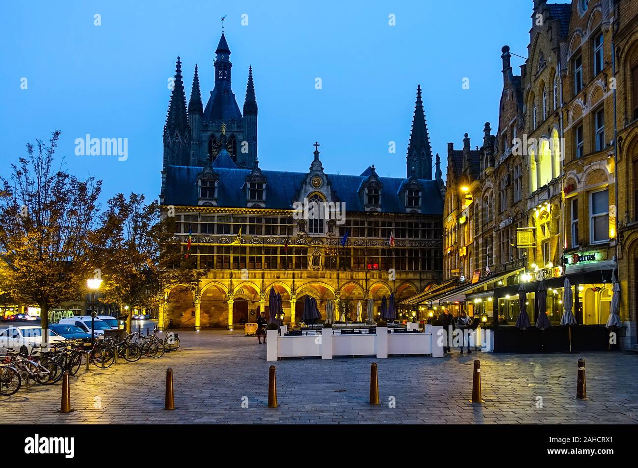 Cloth Hall and restaurants in the Grand Markt, Ypres, Belgium, at dusk ...