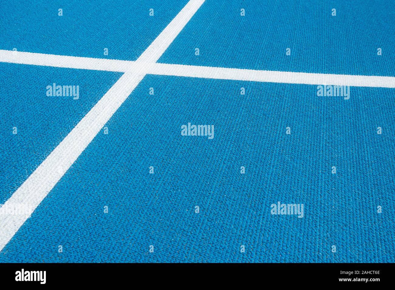Sport background. Blue running track with white lines in sport stadium ...