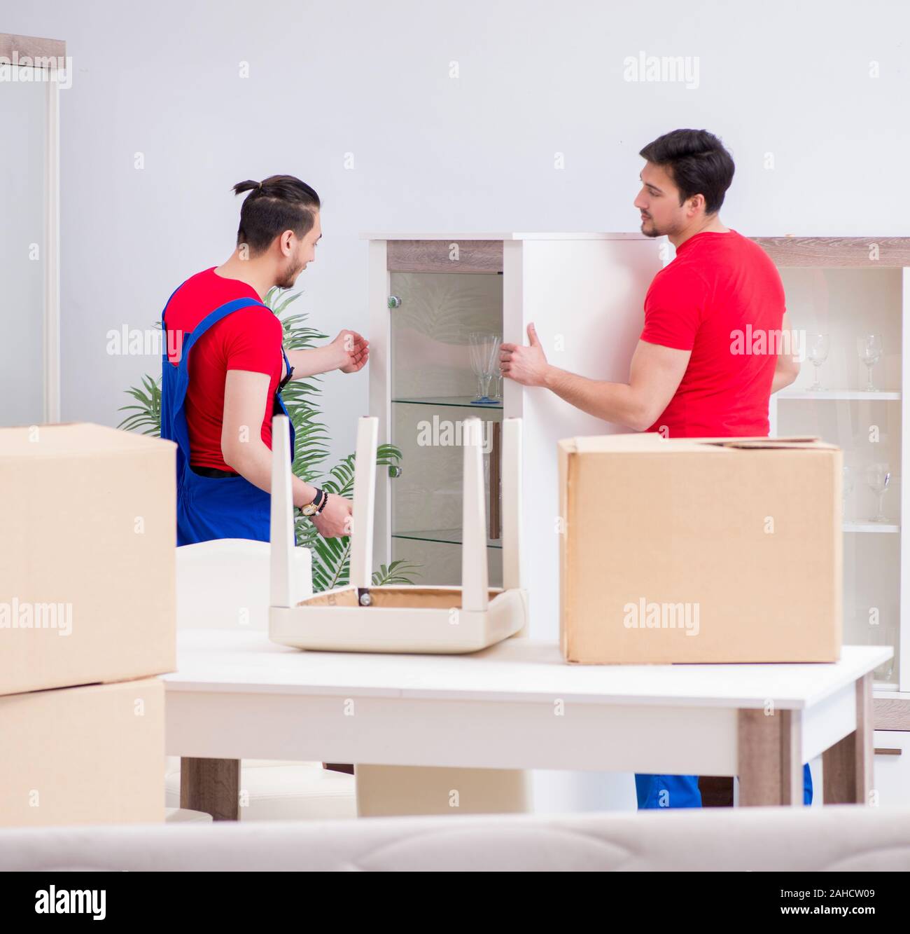 The two contractor employees moving personal belongings Stock Photo - Alamy