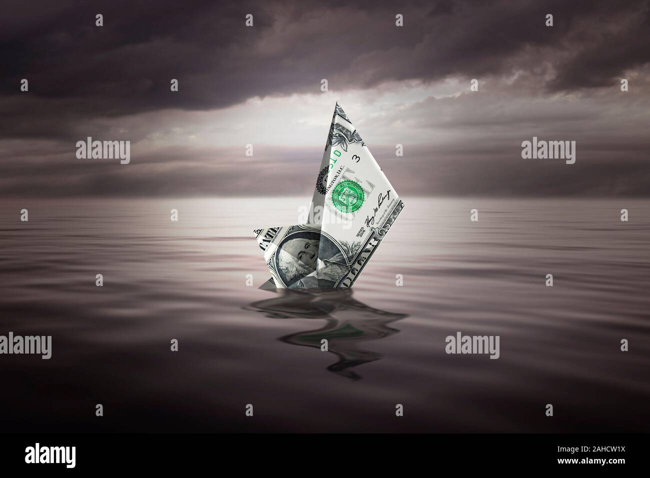 Sinking a little boat made with a dollar bill Stock Photo - Alamy
