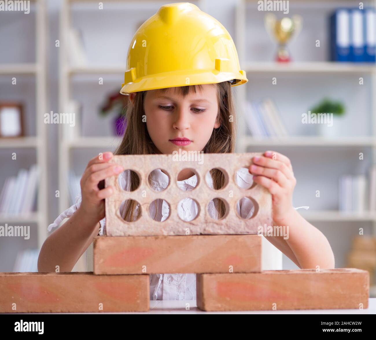 The young girl building with construction bricks Stock Photo - Alamy
