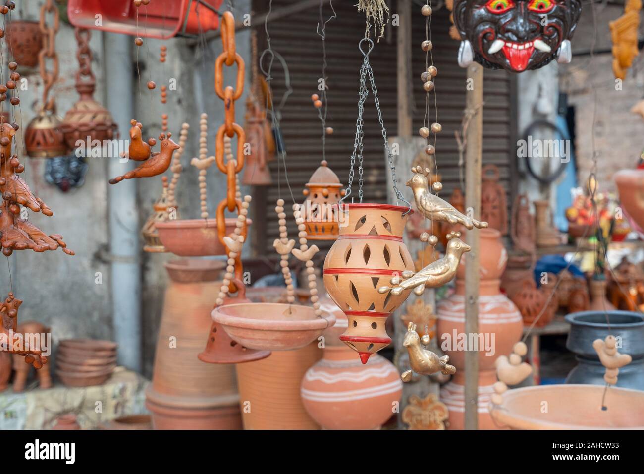 Various windchimes and other hanging decorations made of terracotta ...