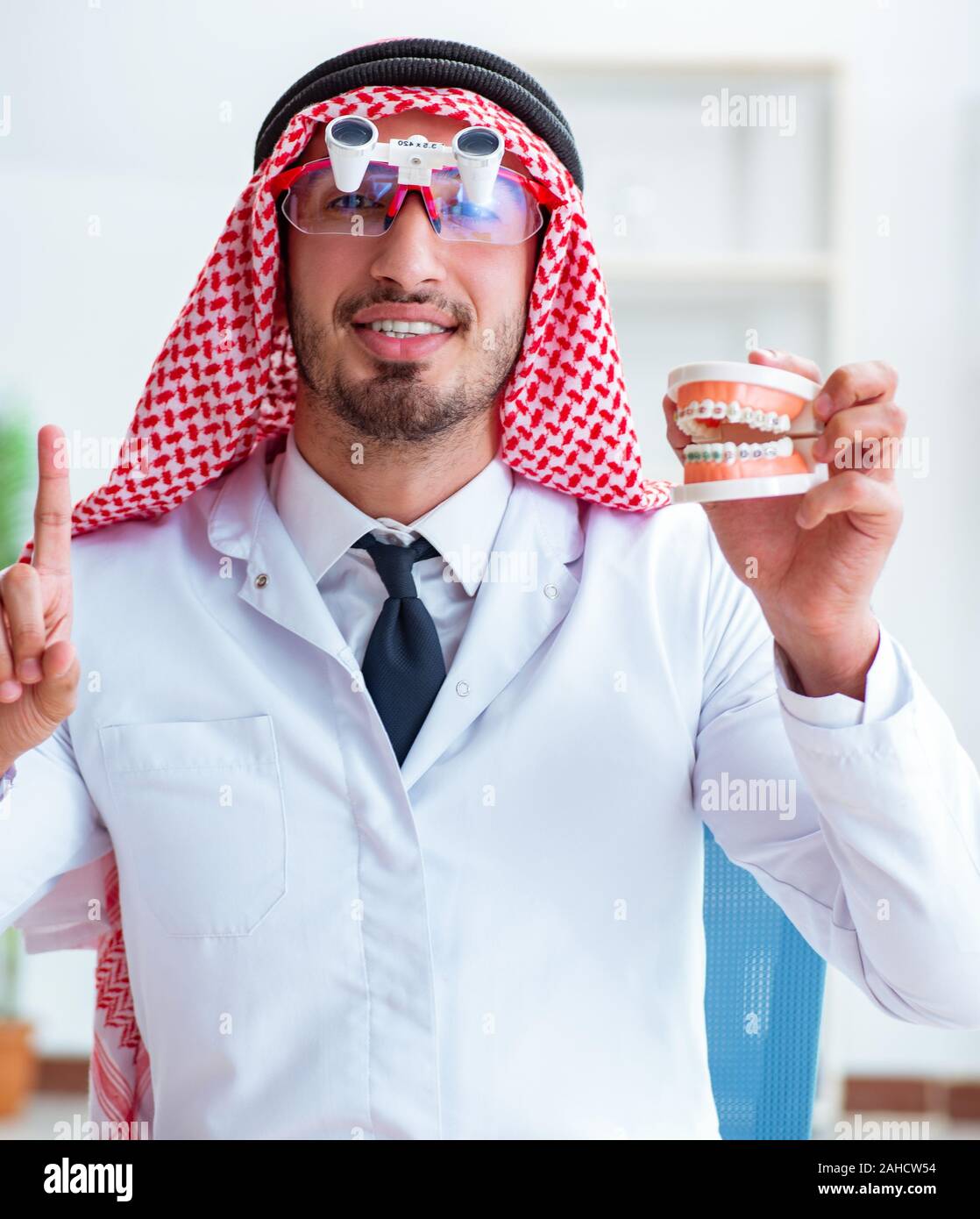 The arab dentist working on new teeth implant Stock Photo - Alamy
