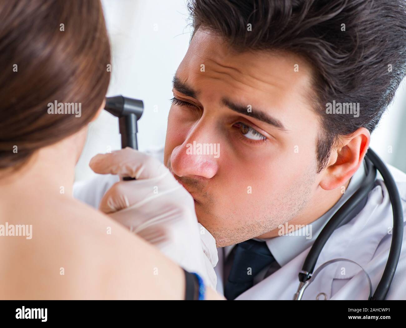 The doctor checking patients ear during medical examination Stock Photo ...