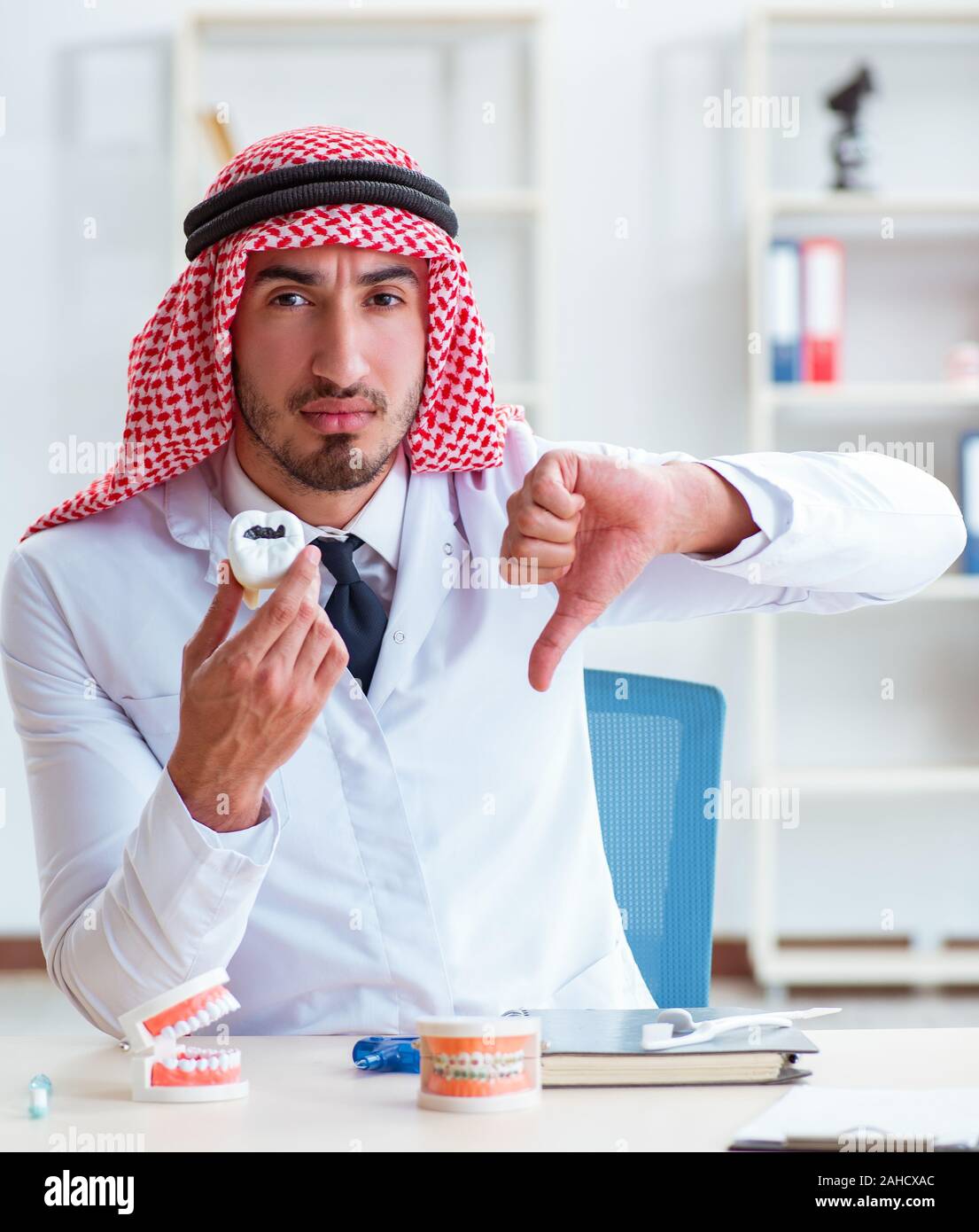 The arab dentist working on new teeth implant Stock Photo - Alamy