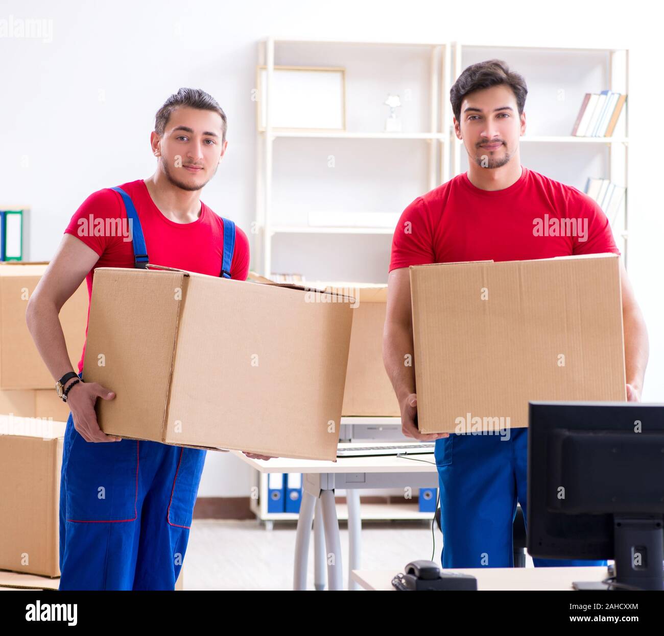 The two contractor employees moving personal belongings Stock Photo - Alamy